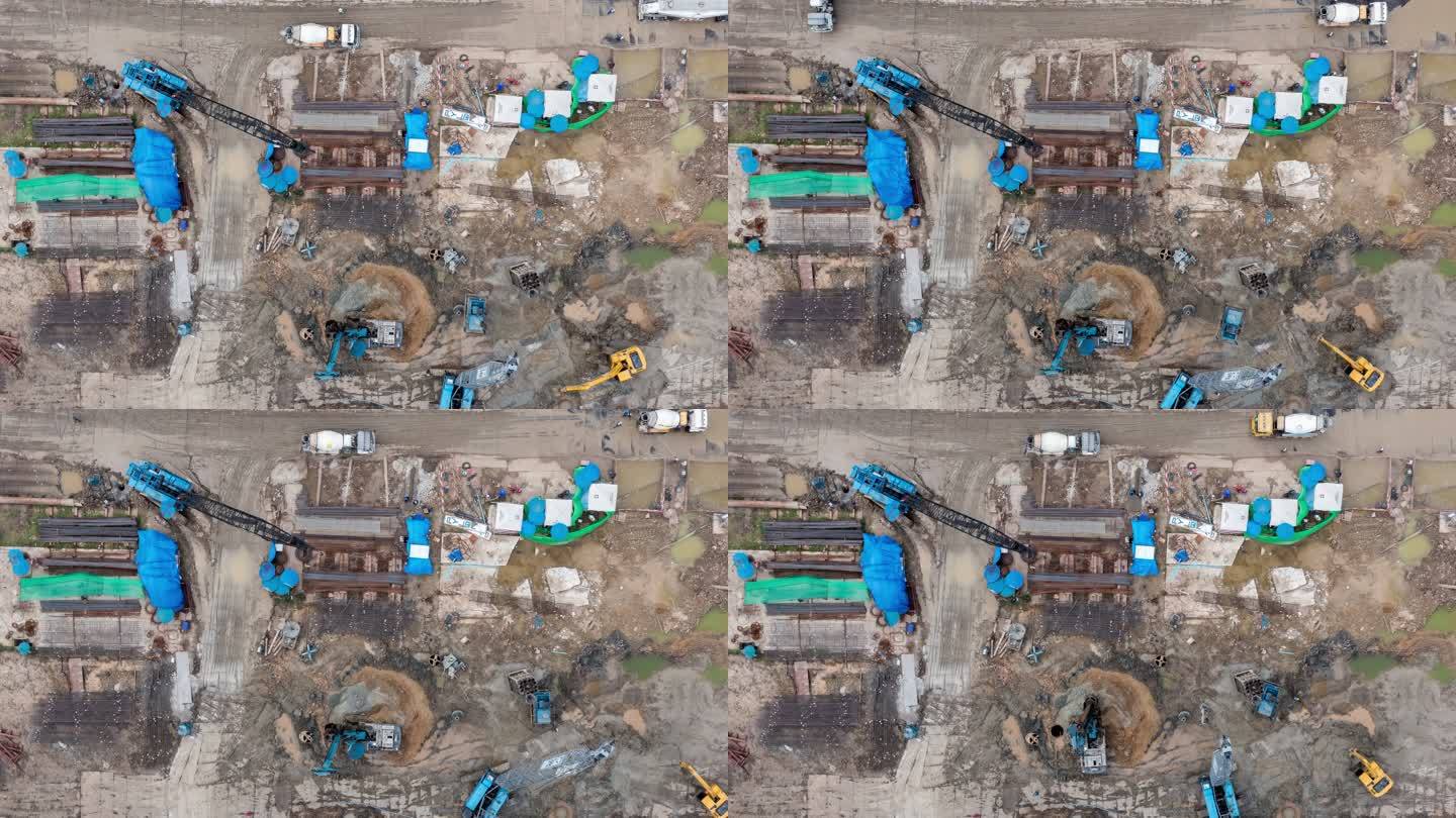 高角度空中俯瞰无人机的视点在大型建筑工地上空随时间推移,有许多大型起重机和机械车辆在白天工作。视频素材下载编号9470919光厂vj师网